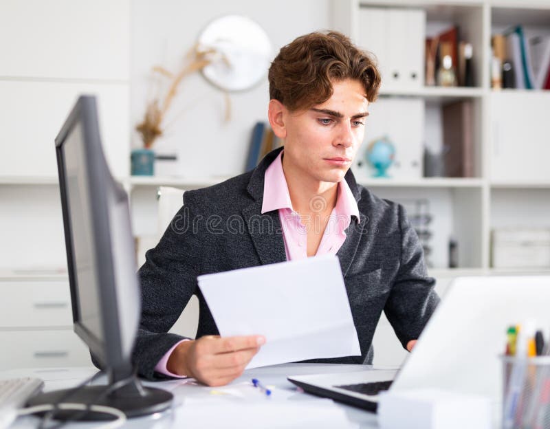 Attractive Thoughtful Young Man Working with Documents Stock Photo ...