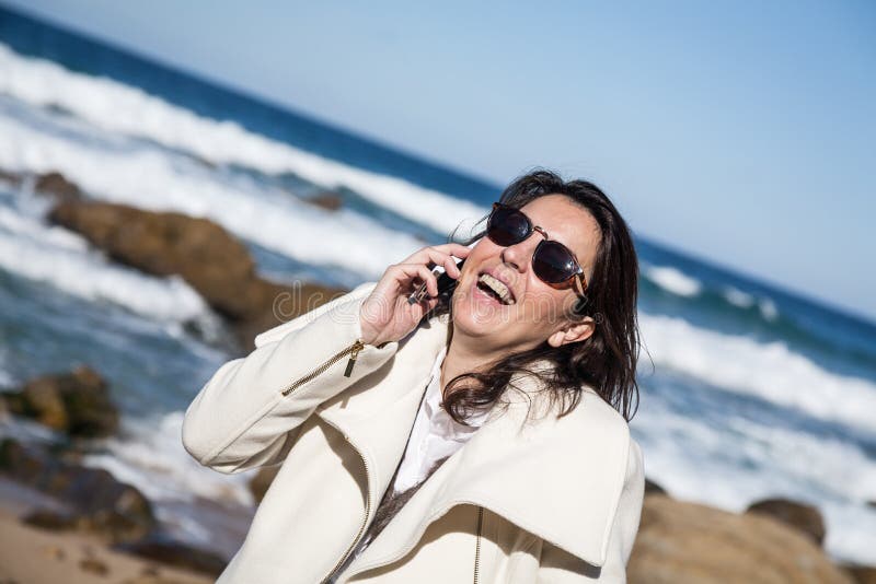Attractive Woman on Beach Talking on the Phone Stock Photo - Image of ...