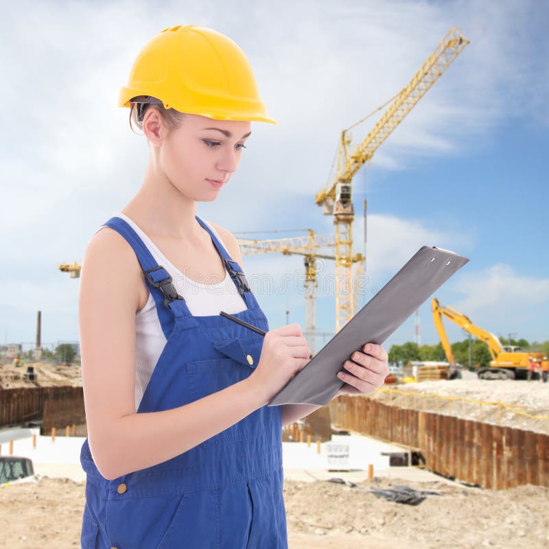 Attractive Woman Builder Writing Something in Clipboard Stock Photo ...