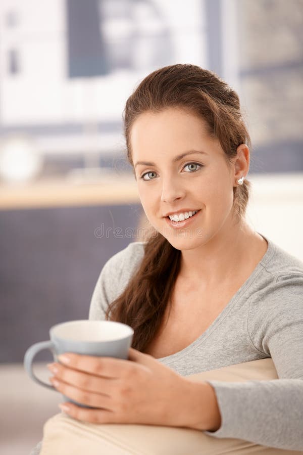 Attractive Woman Drinking Tea on Sofa Smiling Stock Image - Image of ...