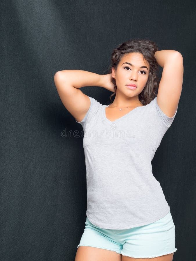 Attractive Woman Leaning Against Wall Stock Image - Image of african ...