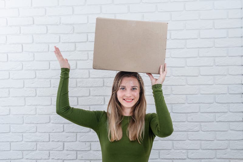 Attractive Woman with Parcel Box on Her Head. Delivering a Parcel Stock ...