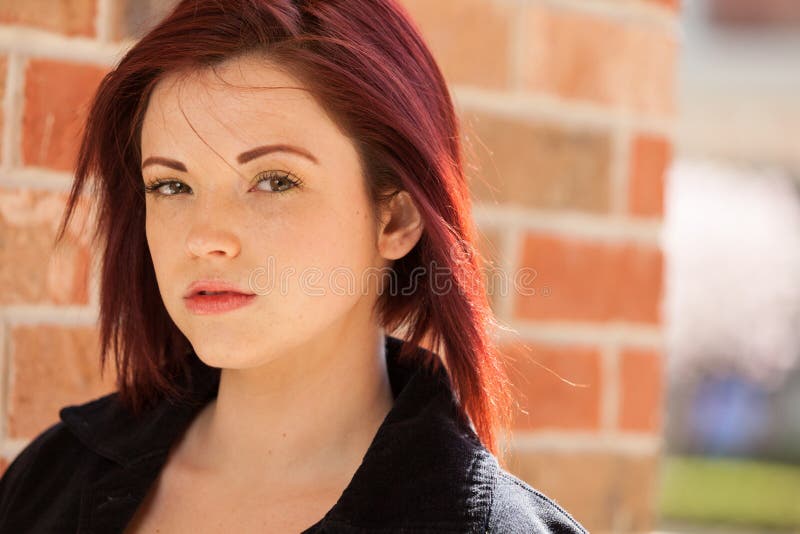 Attractive Woman Posing in Front of a Red Brick Wall Stock Image ...