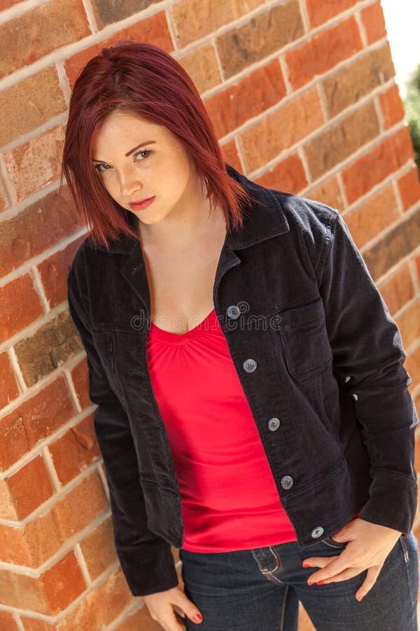 Attractive Woman Posing in Front of a Red Brick Wall Stock Photo ...