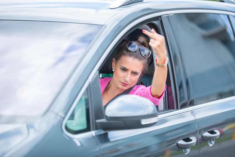 Attractive Woman Shows Obscene Gesture from a Car Stock Image - Image ...