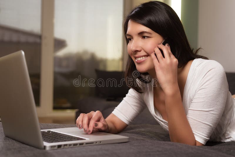 Attractive Woman Using a Mobile Phone and a Laptop Stock Photo - Image ...