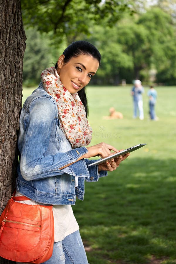 Attractive Woman Using Tablet in Park Smiling Stock Photo - Image of ...