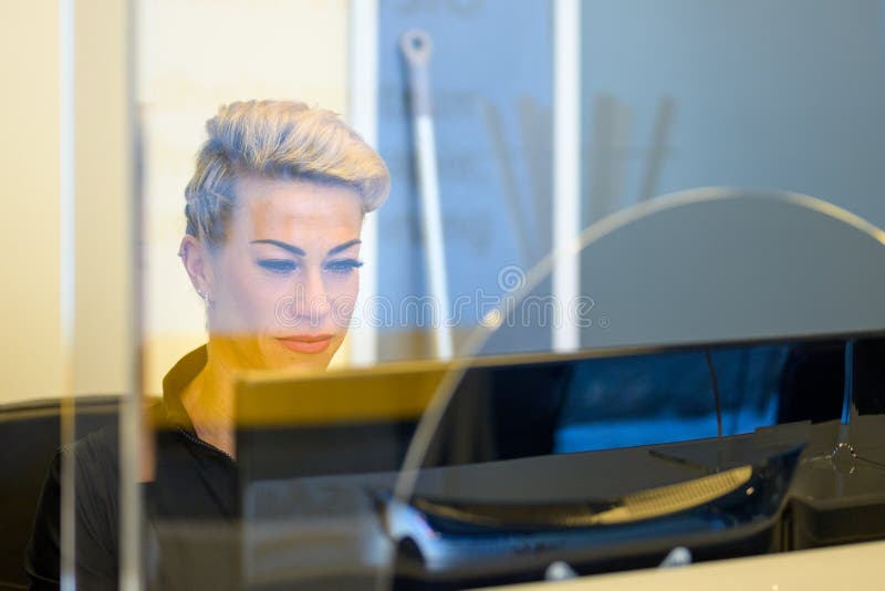 Attractive Woman Working at a Computer Behind Glass Stock Image - Image ...