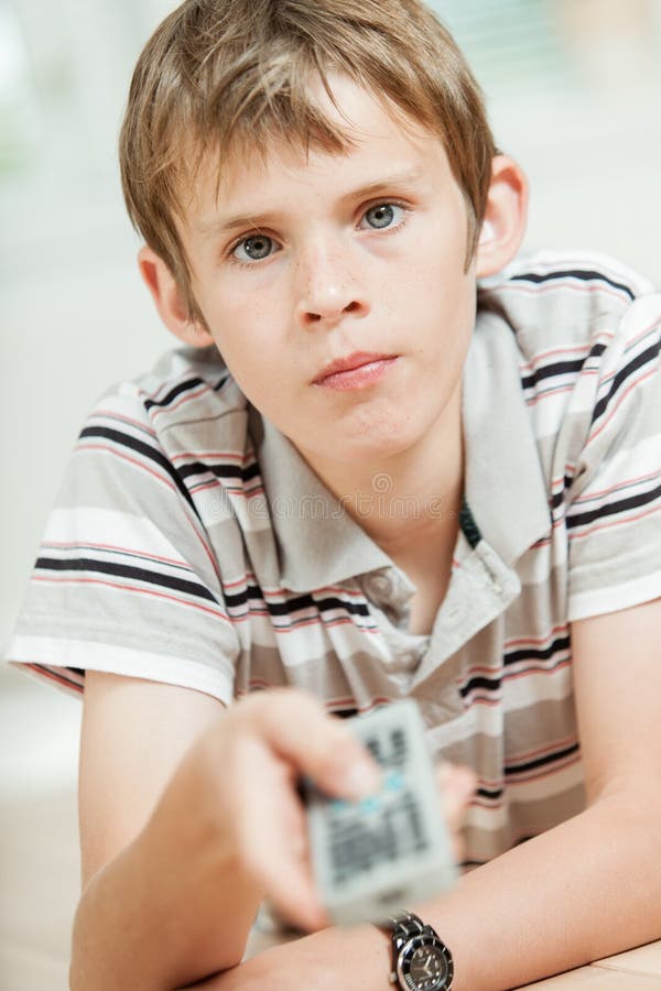 Attractive Young Boy Using a Remote Control Stock Photo - Image of ...
