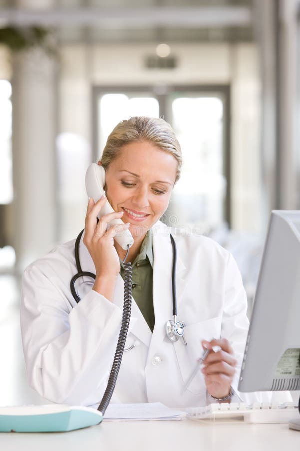 Doctor calling on phone stock image. Image of computer - 8377815
