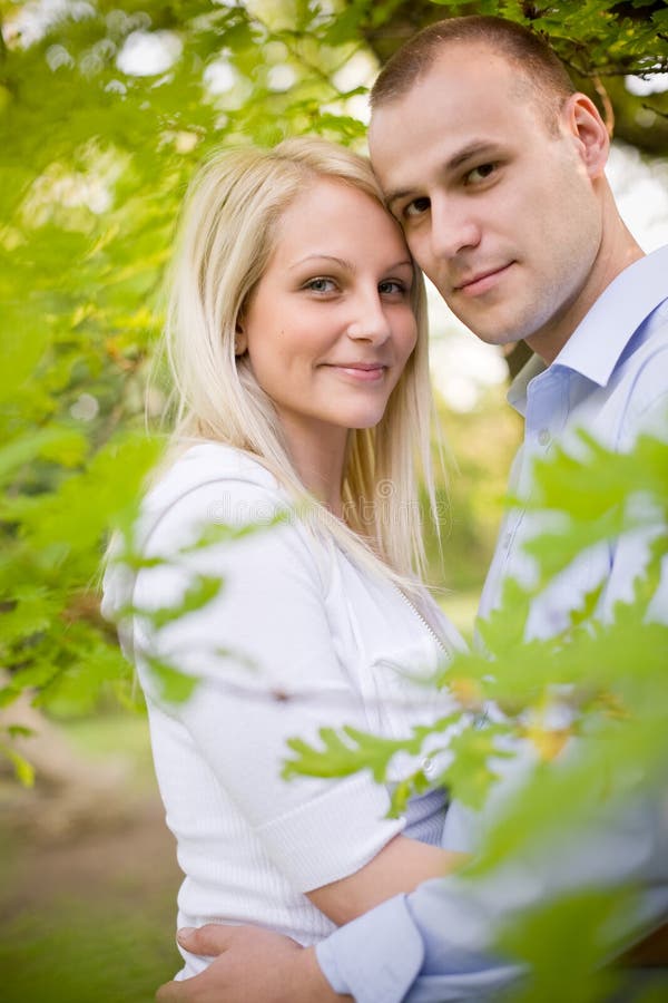 Attractive Young Couple Cuddling. Stock Image - Image of green ...