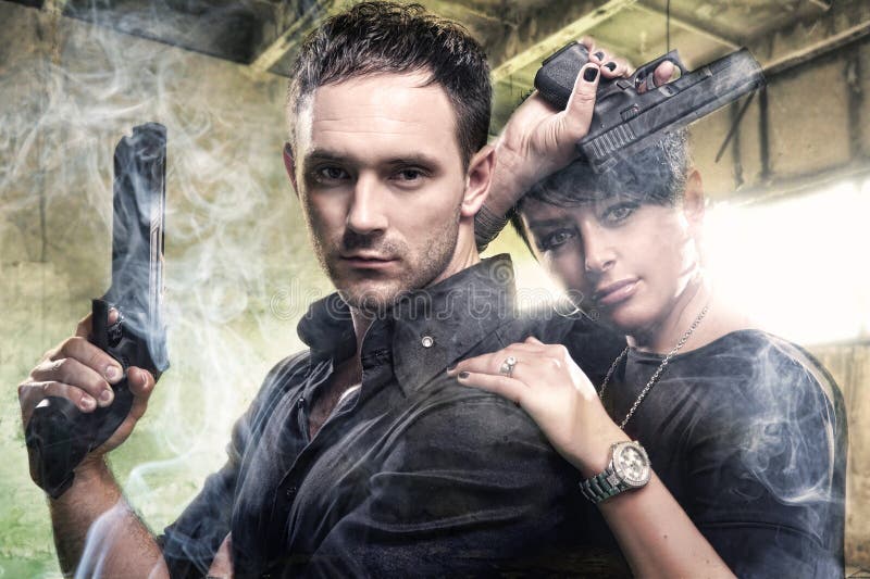 An Attractive Young Couple with Guns Stock Photo - Image of armed ...