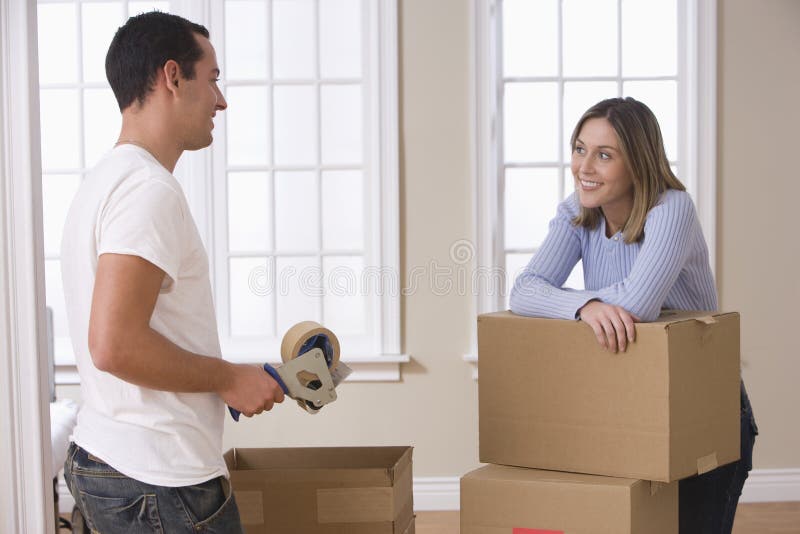 Attractive Young Couple Packing and Smiling Stock Image - Image of ...