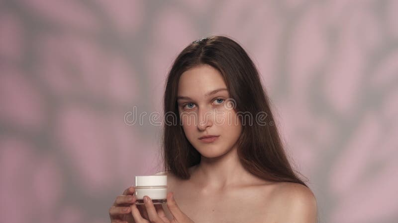 Attractive Young Girl With Long Hair Holding A Small Jar Of Cream Stock Image Image Of
