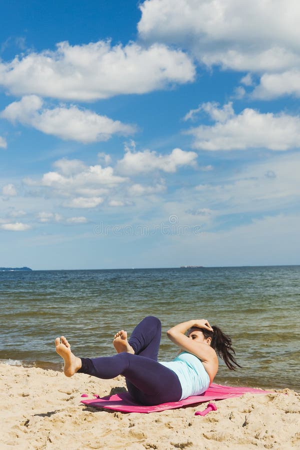 Attractive Young Girl Practicing Physical Exercises on a Beach in the ...