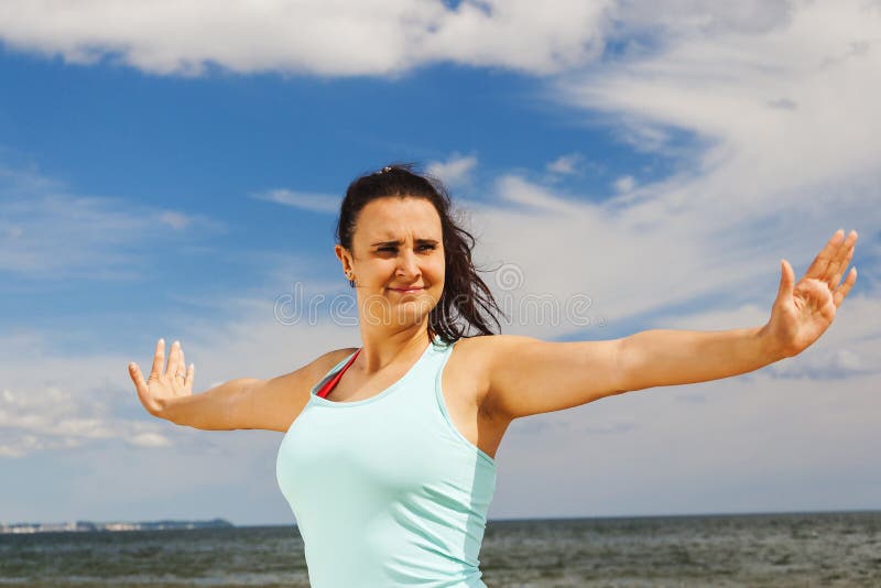 Attractive Young Girl Practicing Physical Exercises on a Beach in the ...