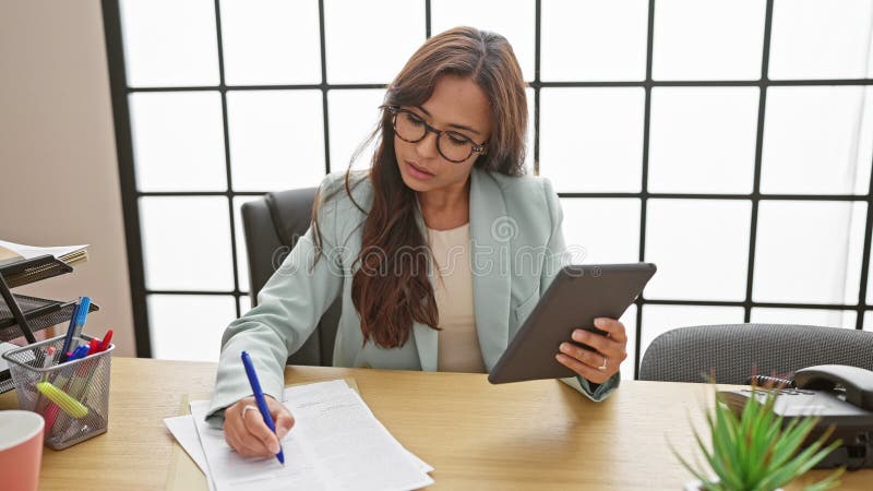 Attractive Young Hispanic Woman Busy Working, Elegantly Glancing at Her ...