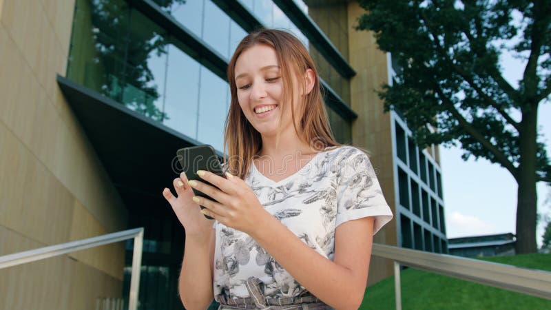 Young Lady Using a Phone in Town Stock Image - Image of charming ...
