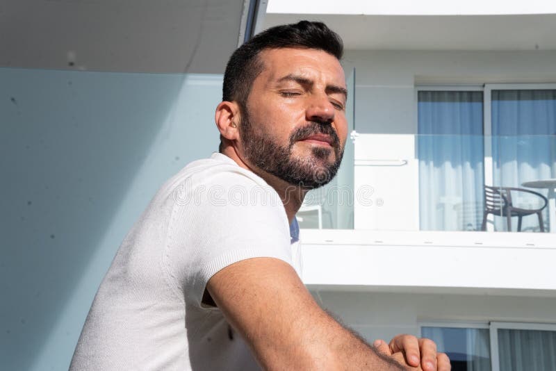 Attractive Young Man on the Balcony of the Hotel Room Looking Around ...