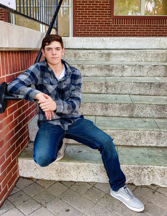 Attractive Young Man Full of Confidence Sitting on Stairs Stock Photo ...