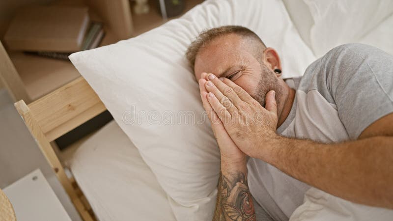 Attractive Young Man Lying in Bed, Crying, Displaying Sadness in the ...