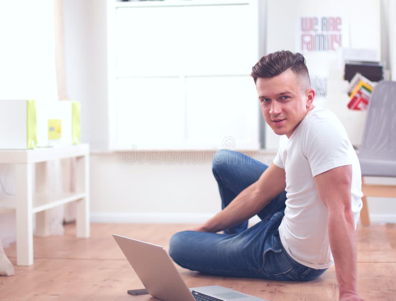 Attractive Young Man Lying on Wooden Floor and Using Laptop Stock Image ...