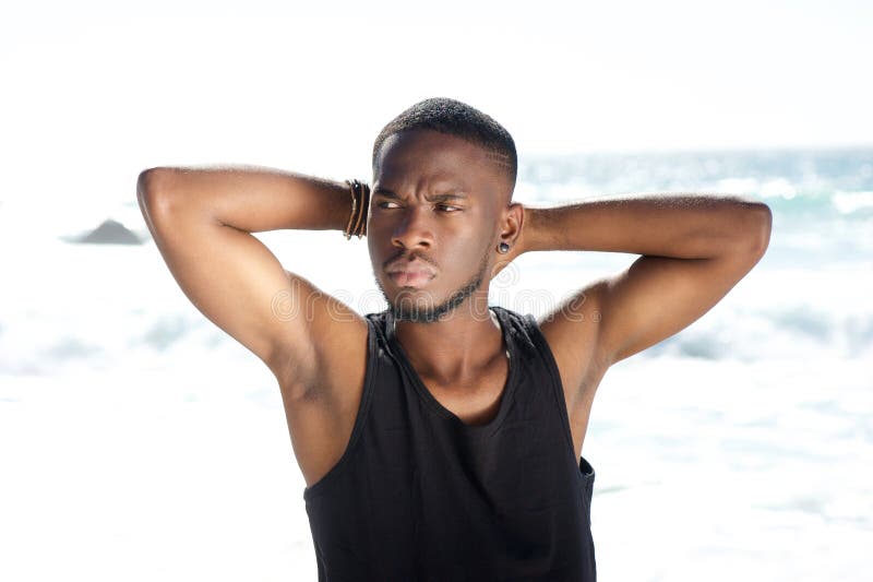 Attractive Young Man Posing with Hands Behind Head at Beach Stock Photo ...