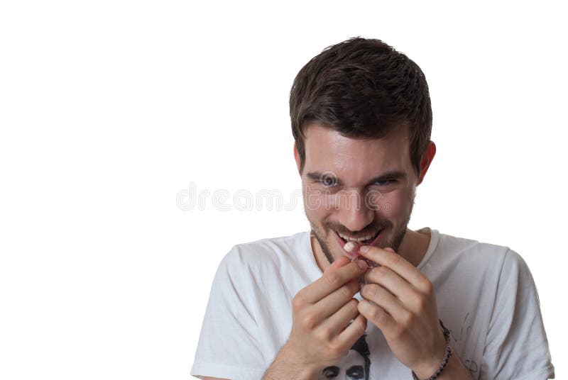 Attractive Young Man Putting a Candy in His Mouth Stock Photo - Image ...