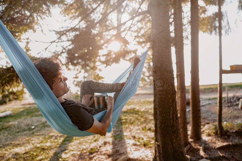 Attractive Young Man Resting in Hammock with Coffee, Tea in Hammock in ...
