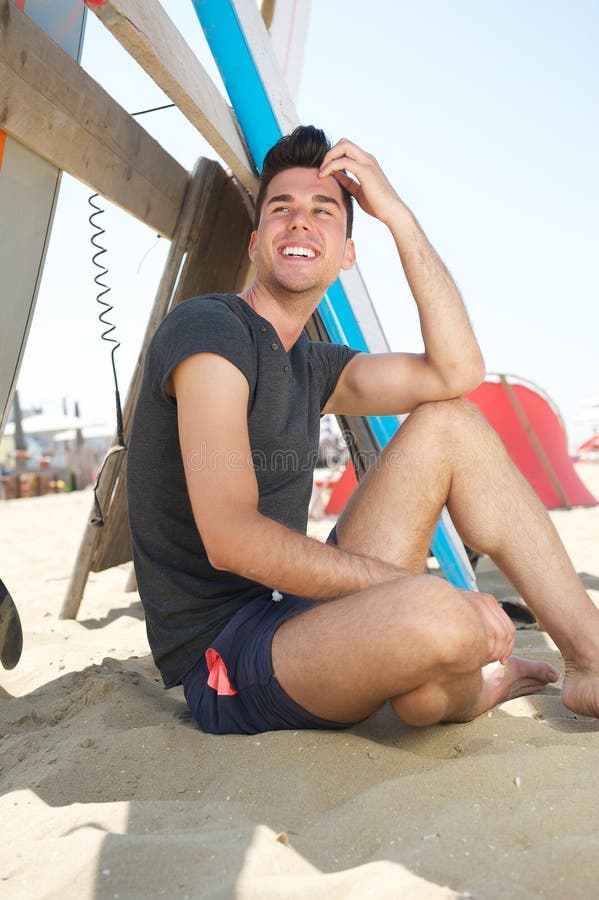 Attractive Young Man Sitting at the Beach Stock Photo - Image of ...
