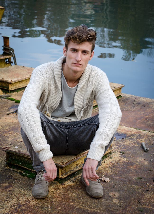 Attractive Young Man Sitting on Rusty Metal Next To River Stock Image ...