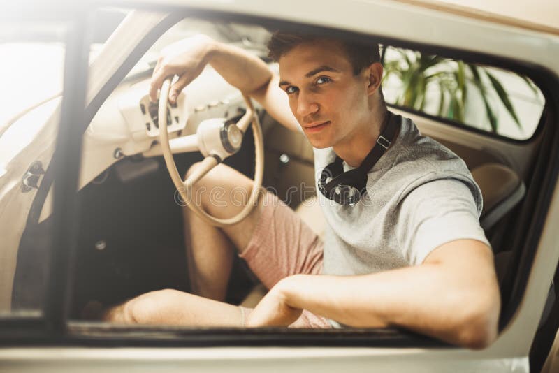 An Attractive Young Man is Sitting in a Vintage Car Stock Image - Image ...
