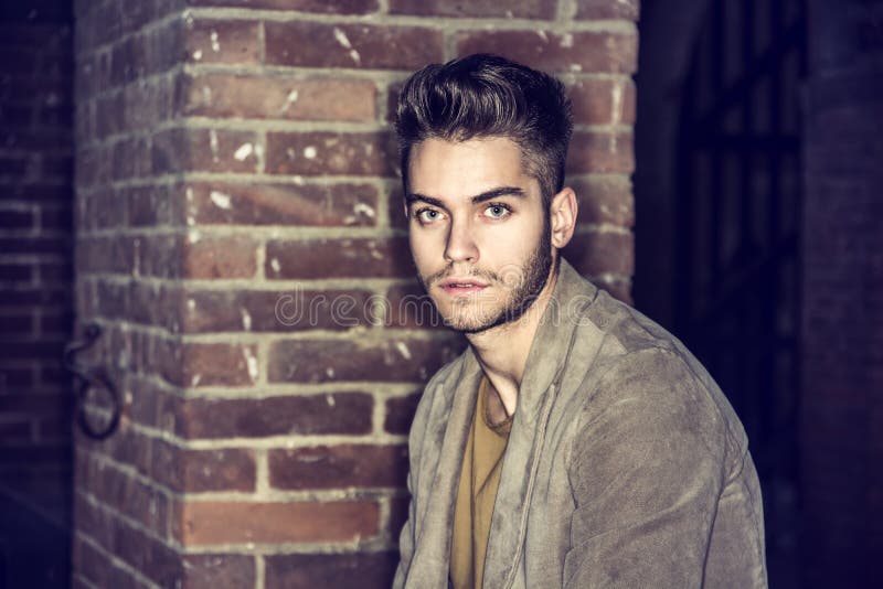 Attractive Young Man Standing Against Brick Wall Stock Photo - Image of ...