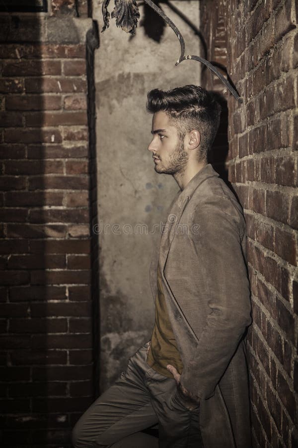 Attractive Young Man Standing Against Brick Wall Stock Photo - Image of ...