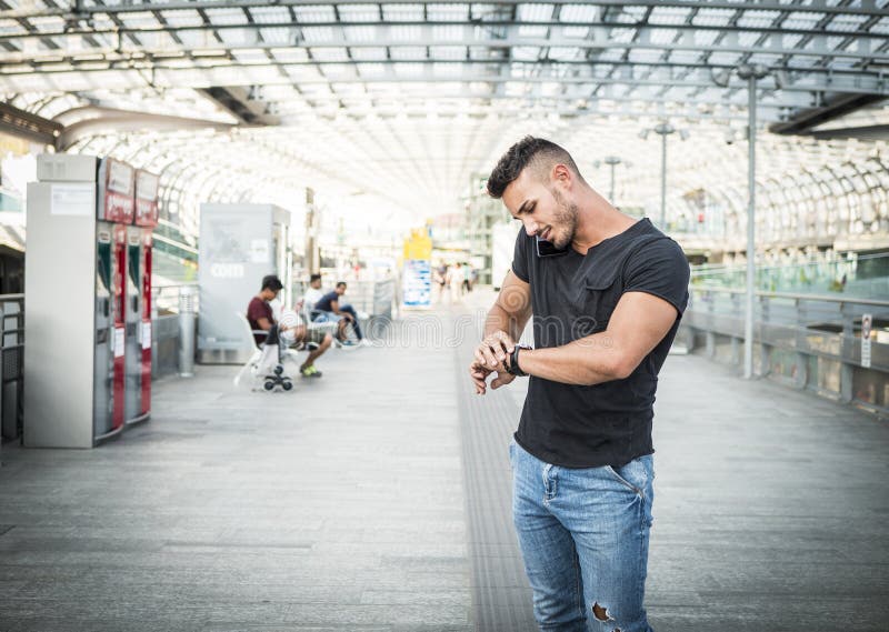 Young Man in Train Station Calling on Cellphone Stock Photo - Image of ...