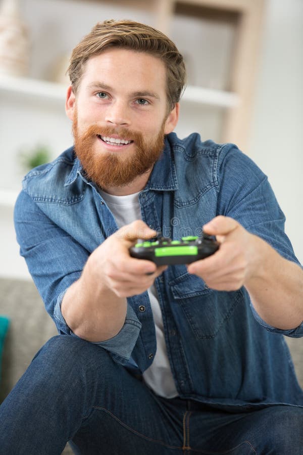 Attractive Young Man Using Joystick or Joypad for Videogames Stock ...