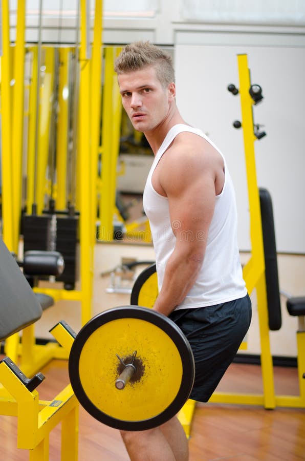 Attractive Young Man Working Out with Barbell at Gym Stock Photo ...