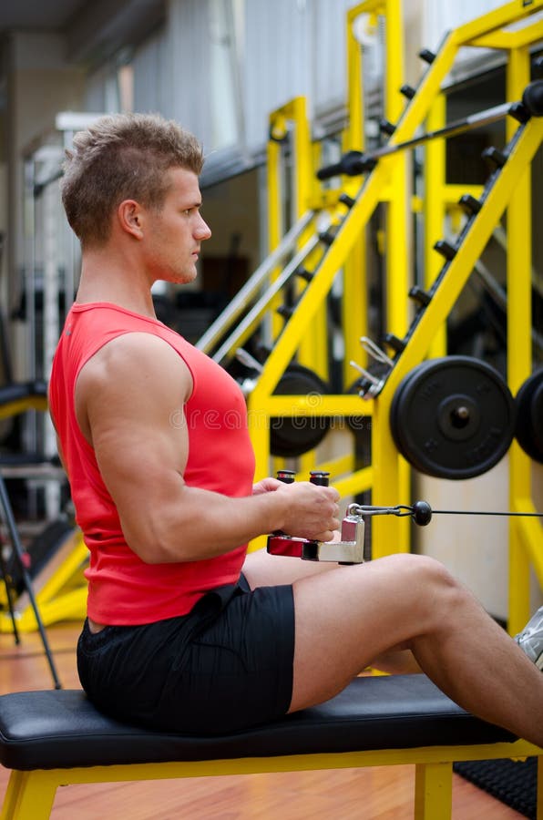Attractive Young Man Working Out on Gym Equipment Stock Image - Image ...