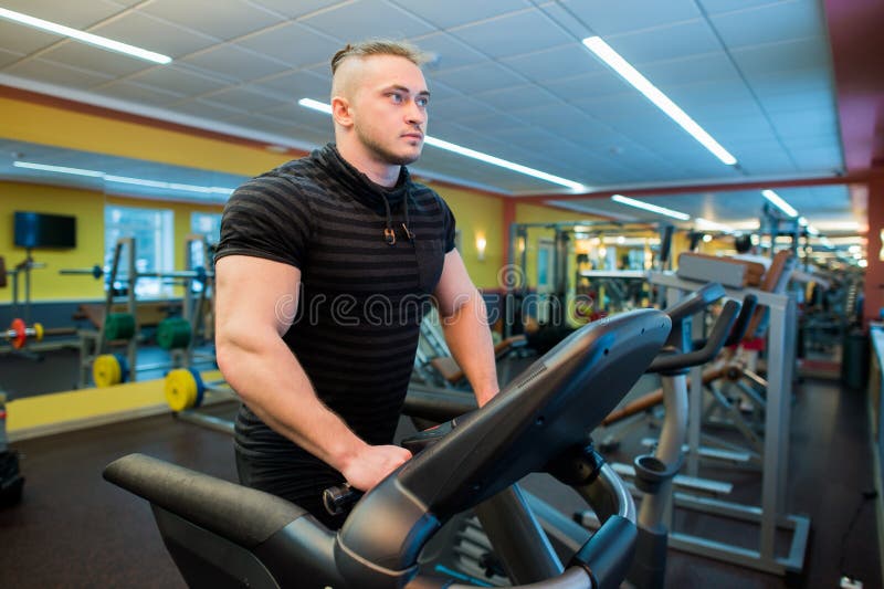 Attractive Young Muscular Man while Running on a Treadmill in Gym Stock ...