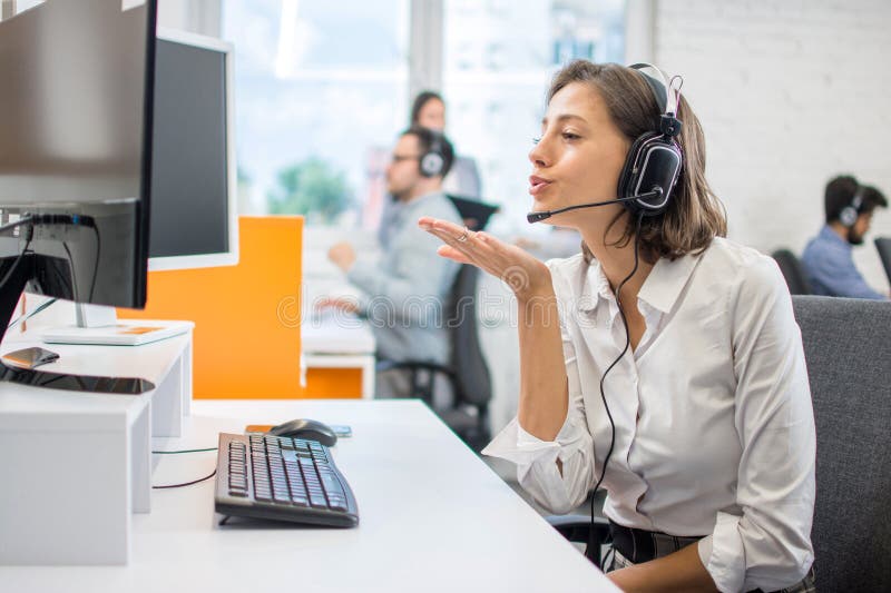 Attractive Young Operator Woman Blowing a Kiss To Computer Screen ...