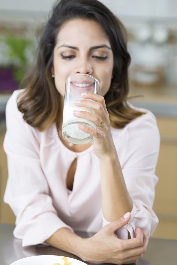 Attractive Young Woman Drinking Milk Stock Photo - Image of indoors ...