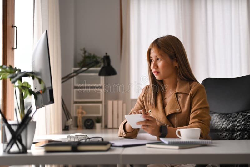 Attractive Young Woman Looking at Computer Screen, Analyzing Financial ...