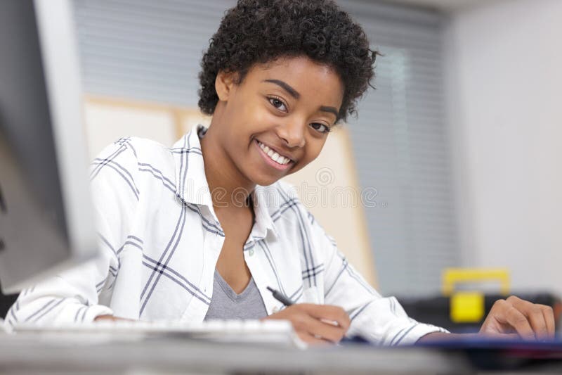 Attractive Young Woman with Pen in Hand Looking at Camera Stock Image ...
