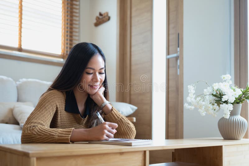 Attractive Young Woman Taking Notes with a Smile in Minimalist Room ...