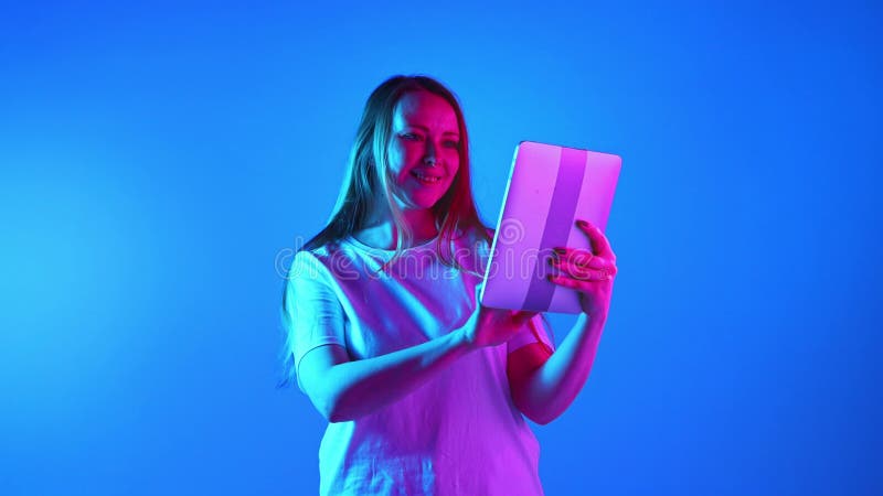 Attractive Young Woman Using Tablet and Scrolling News Feed and Smiling ...