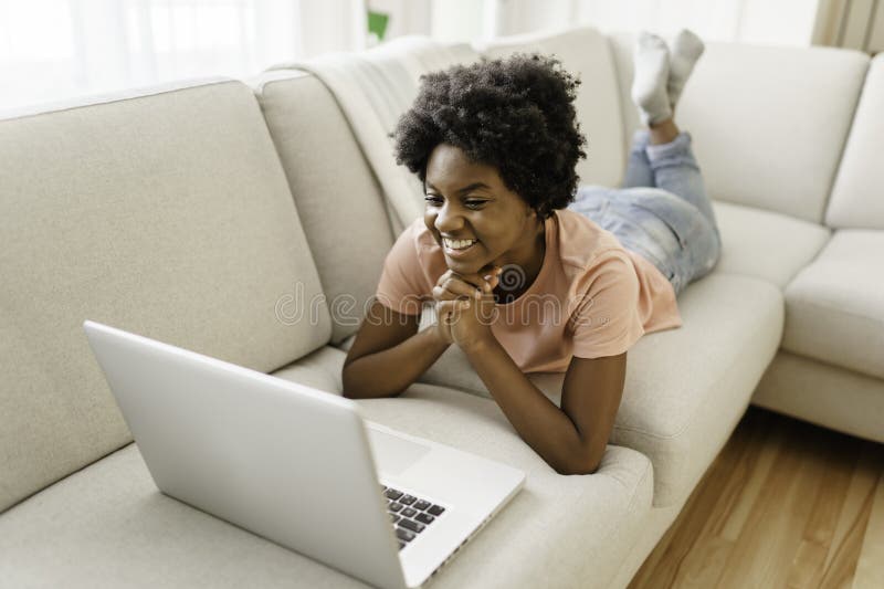 Attractive Young Woman Working with Laptop on Couch Stock Photo - Image ...