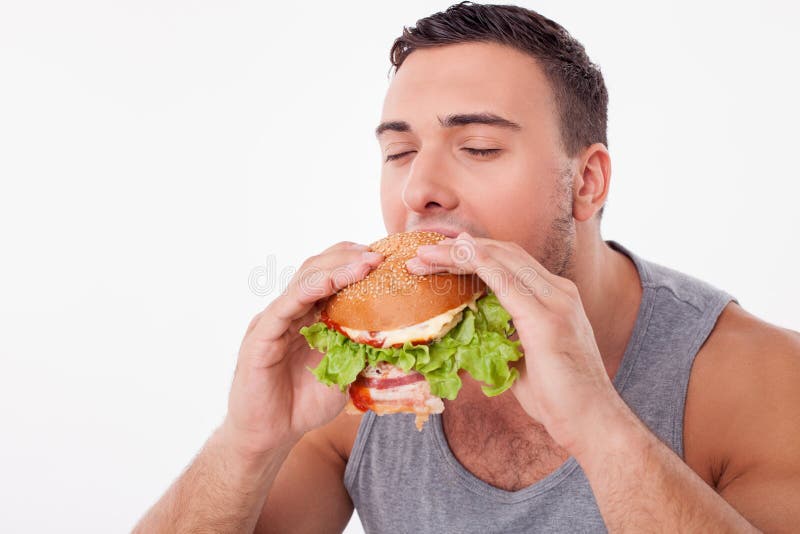 Attraktiver Junger Mann Isst Ungesunden Hamburger Stockbild - Bild von ...