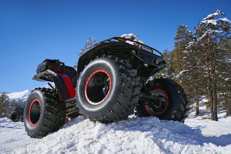 ATV with Big Wheels on the Snow Stock Photo - Image of large, adventure ...