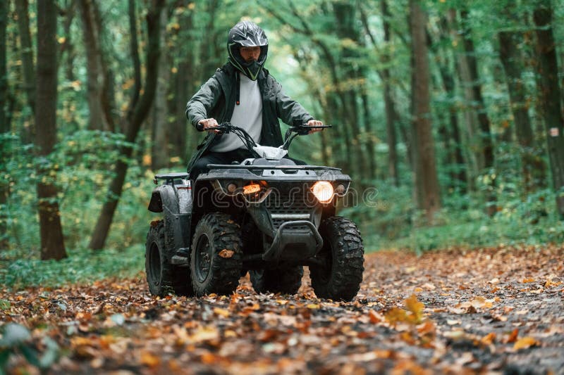 ATV Driver is in the Forest, Having a Ride at Daytime Stock Photo ...