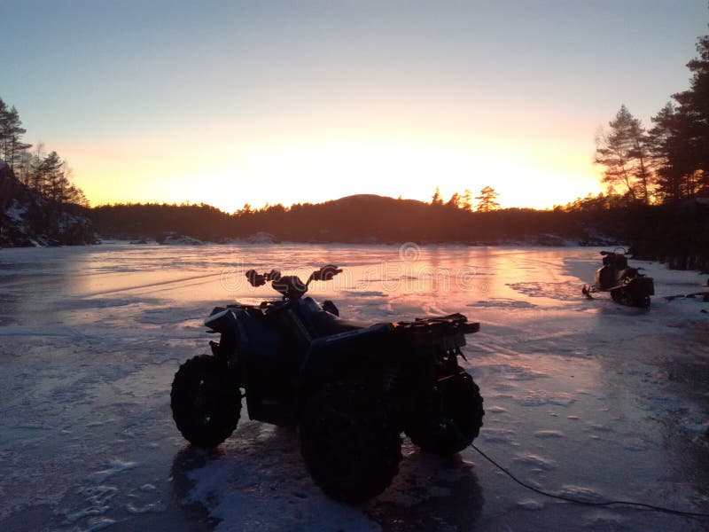 Atv on ice in sunset stock photo. Image of norway, southern - 125765576